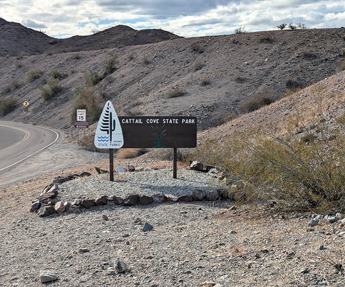 The entrance sign stands like a promise in the desert: beyond this point, swimming suits are more useful than hiking boots.