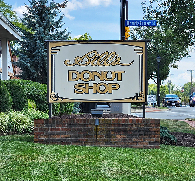 The sign stands like a beacon of hope in a world of mass-produced pastries. "Abandon diets, all ye who enter here."