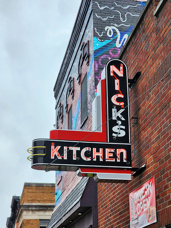 Even at dusk, Nick's Kitchen's neon sign shines like a delicious promise against the downtown Huntington skyline tonight.