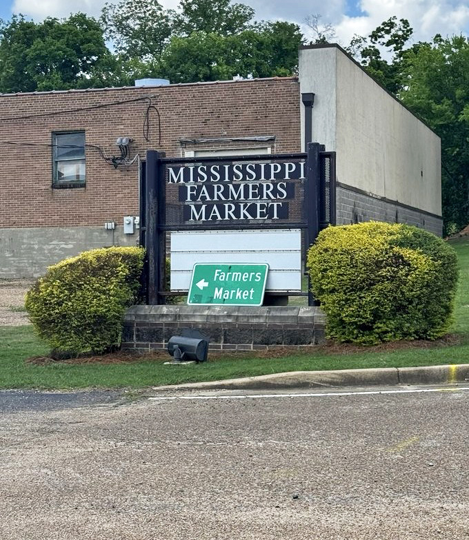 The sign says "Farmers Market" but it might as well read "Happiness Headquarters" – a beacon for those seeking edible authenticity in an increasingly processed world.