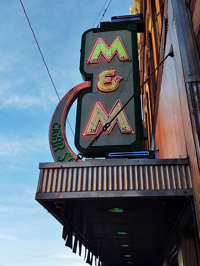 The iconic neon M&M sign glows against the Montana sky, a beacon for hungry travelers and locals alike since long before GPS.