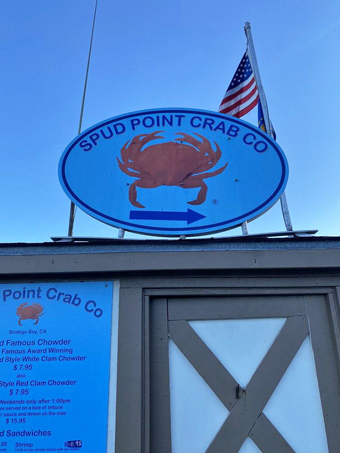 The blue oval sign beckons like a lighthouse for hungry travelers&mdash;follow the crab to find your coastal culinary salvation.