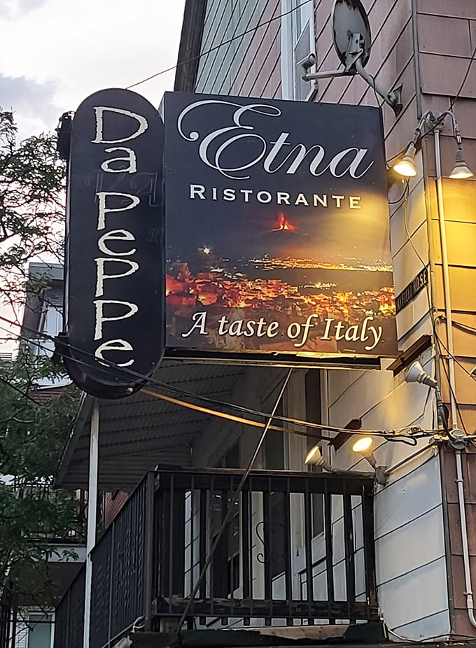 The sign promises "A taste of Italy" – an understatement as bold as the volcano depicted in the background.