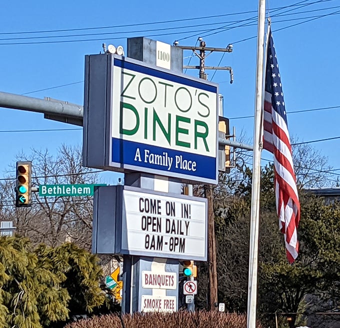 "Come on in!" declares the roadside sign, a friendly invitation that's impossible to resist. The American flag flutters in agreement.