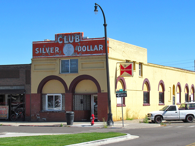 The Silver Dollar Club's distinctive arched windows and bold signage promise the kind of authentic Nevada experience that Vegas casinos spend millions trying to replicate.