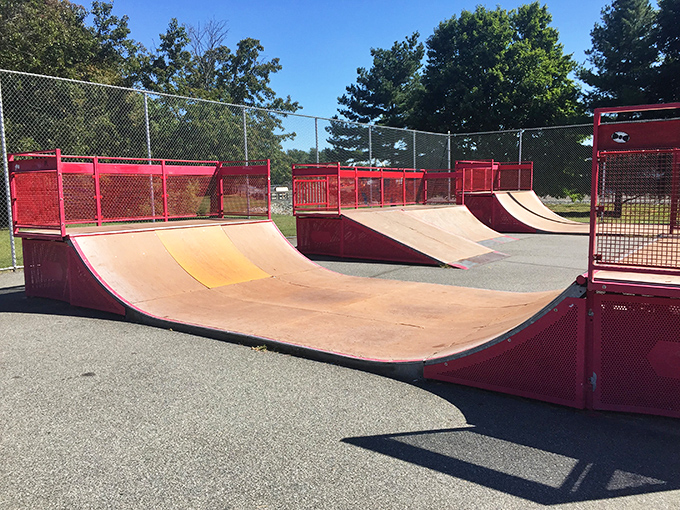 The skatepark's flowing red ramps offer local youth a canvas for gravity-defying self-expression and a healthy outlet for teenage energy.