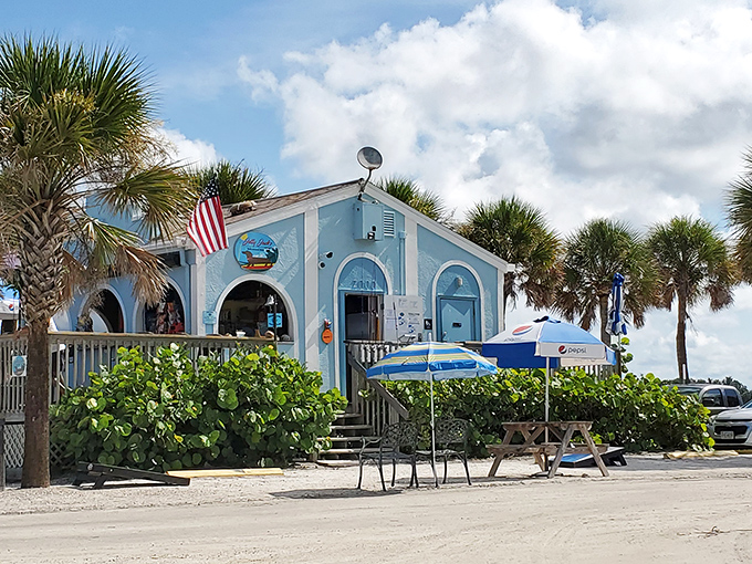South Jetty Beach's charming blue building offers refreshments with a side of Gulf views. Paradise found, with convenient parking.