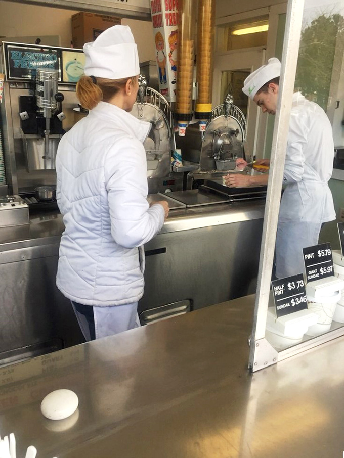 White-uniformed custard artisans practicing their craft with the focus of surgeons. Creating perfection one scoop at a time.