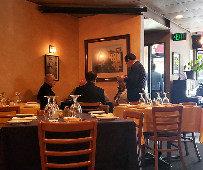The dining room hums with the quiet energy of people engaged in civilization's most important activity: breaking bread together.