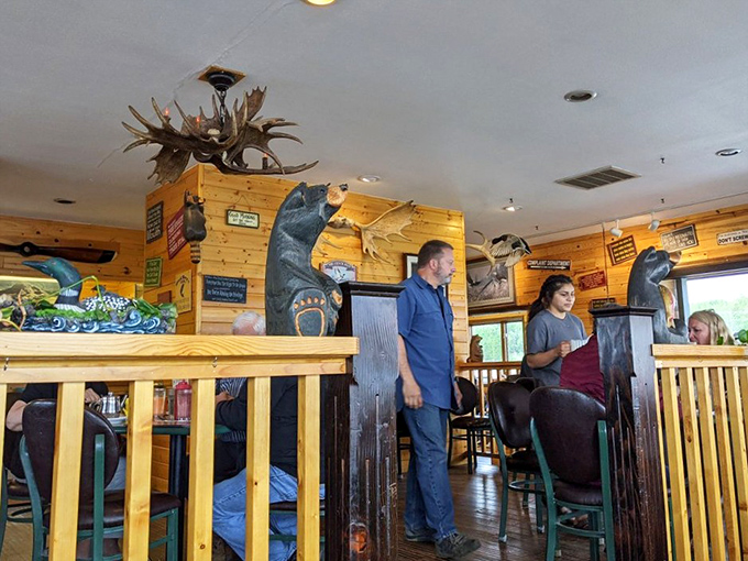 A carved wooden moose wearing Carhartt overalls—the unofficial greeter who's seen thousands of hungry Alaskans come and go, but never judges their pancake consumption.