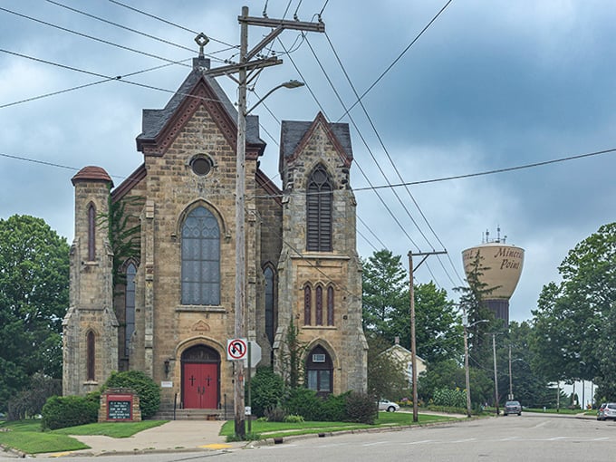 The stone church stands sentinel over the town, its Gothic windows like watchful eyes that have witnessed generations of local history.