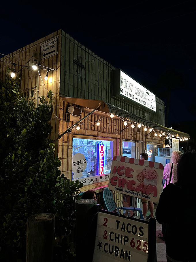 Night lights and beach bites. After dark, the Kooky Coconut glows like a tiki beacon, drawing hungry night owls to its irresistible offerings.