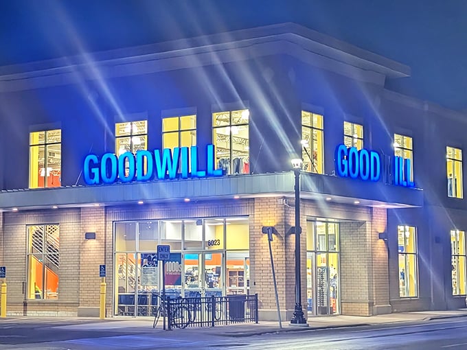 As night falls, the illuminated Goodwill sign glows like a beacon for night owls seeking retail therapy after dark.