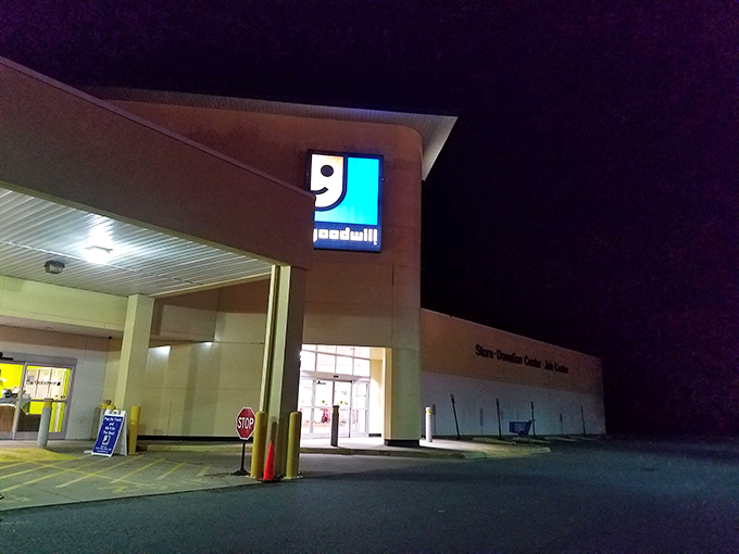 Even after hours, the Goodwill sign glows like a lighthouse for bargain hunters, promising tomorrow's treasures are already waiting inside.