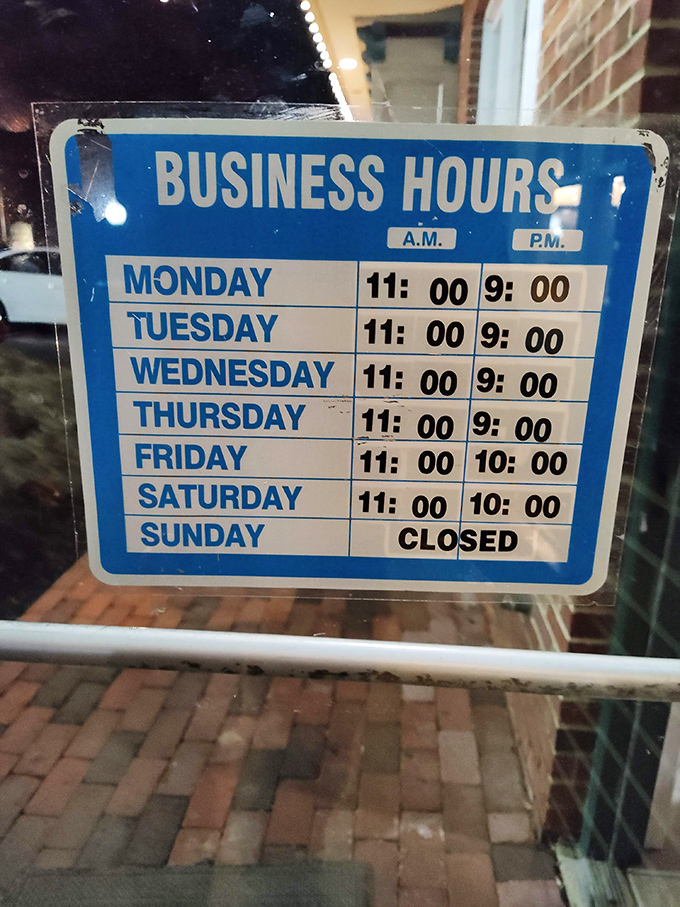 Business hours posted clearly—because knowing when you can get your next cheesesteak fix is information more valuable than your retirement portfolio.
