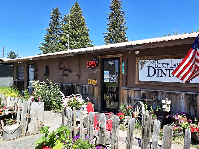 Summer at the Rusty Lantern means flowers frame your approach to prime rib paradise. The American flag isn't decoration—it's part of the diner's DNA.