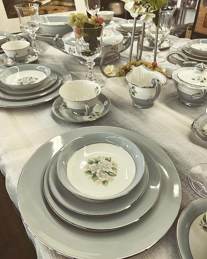 Fine china place settings arranged with the care of a five-star restaurant. Someone's wedding registry becomes your elegant dinner party waiting to happen.