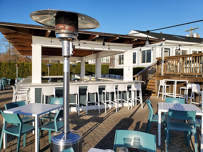 The Beach House's outdoor bar captures that perfect summer vibe&mdash;where cocktails taste better with salt air and harbor views.