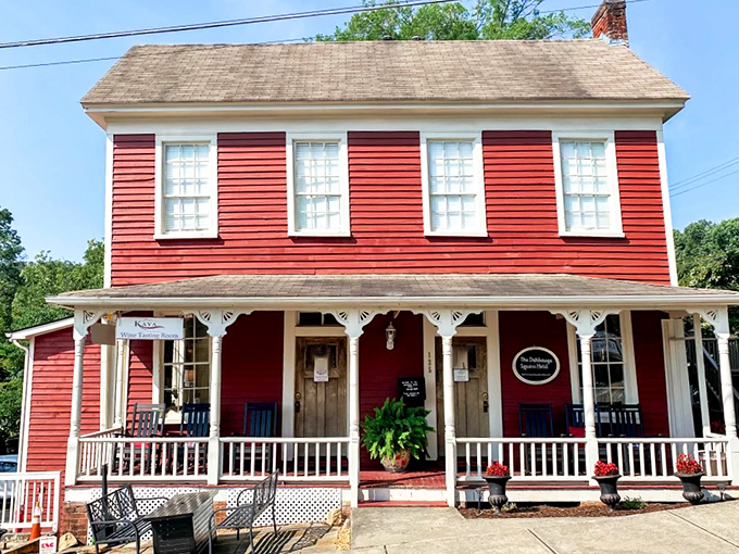 The Dahlonega Square Hotel's vibrant red exterior and welcoming porch invite visitors to rock away an afternoon in true Southern style.