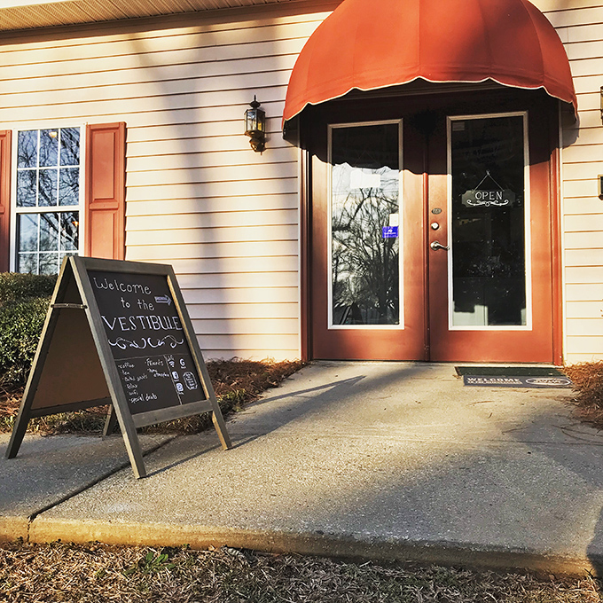 The Vestibule welcomes coffee seekers with charm, an orange awning, and the promise of good caffeine.