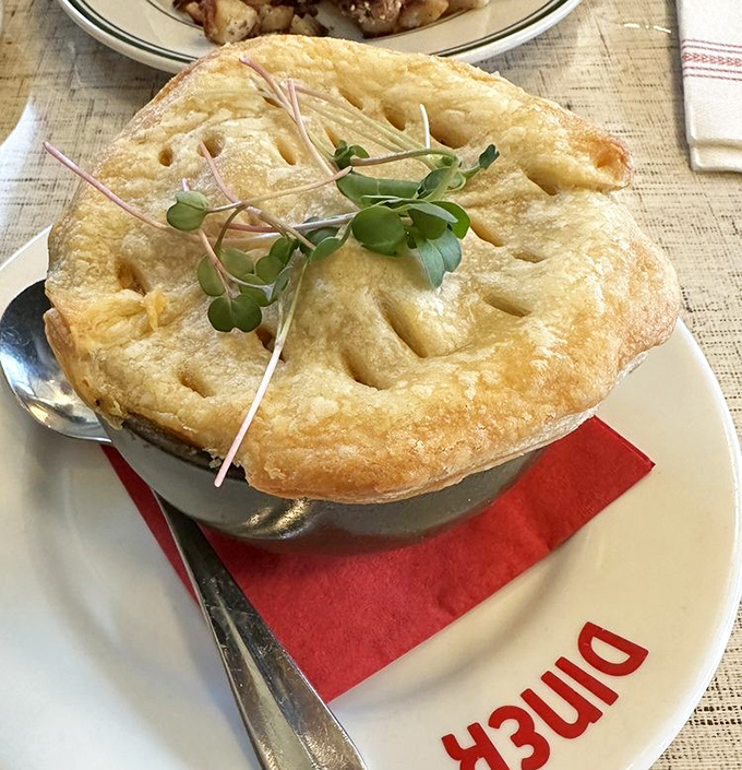 Pot pie with a golden dome that would make Michelangelo weep. That flaky crust is architecture you get to eat with a spoon.