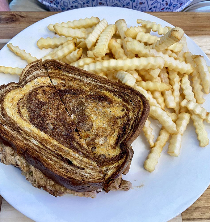 The humble tuna melt elevated to art form &ndash; perfectly grilled bread revealing a molten interior that demands a slow-motion bite.