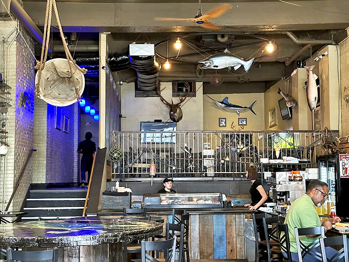 The upstairs dining section offers a bird's-eye view of the seafood action below. Those mounted fish are the ultimate restaurant critics.