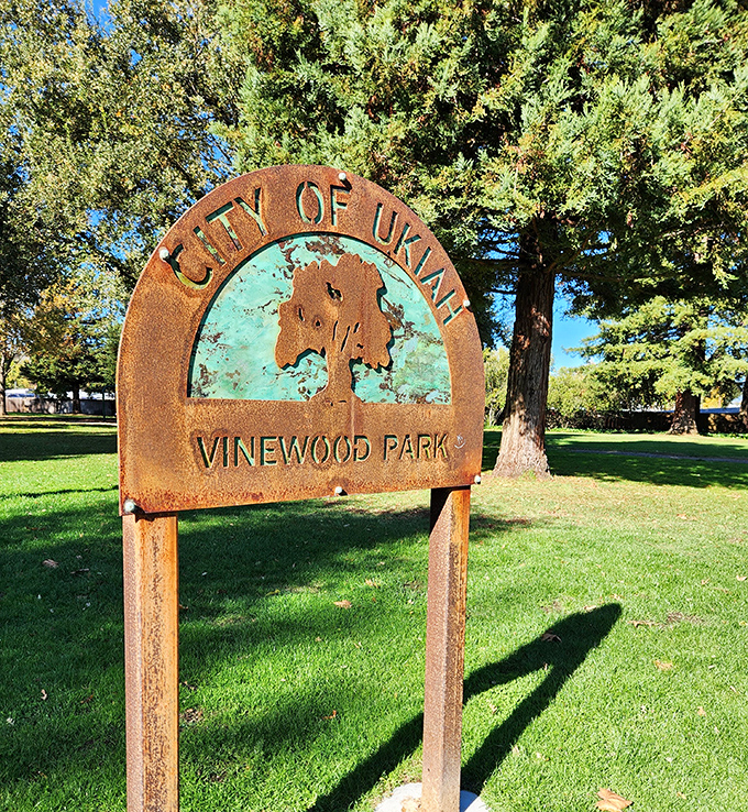 Vinewood Park's rustic sign welcomes visitors to a slice of tranquility where the biggest decision is which bench offers the optimal sunlight-to-shade ratio.