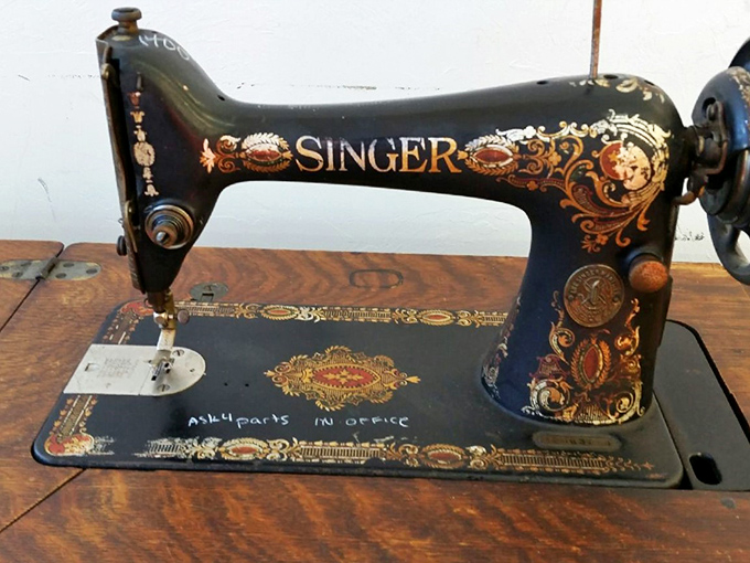A Singer sewing machine with ornate detailing that's equal parts functional tool and museum-worthy art piece. They truly don't make them like this anymore.