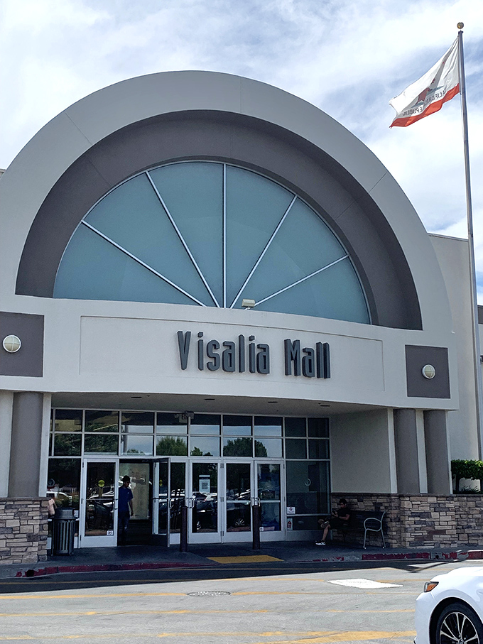 The Visalia Mall's distinctive arched entrance serves as a gateway to air-conditioned shopping – because even explorers sometimes need new socks.