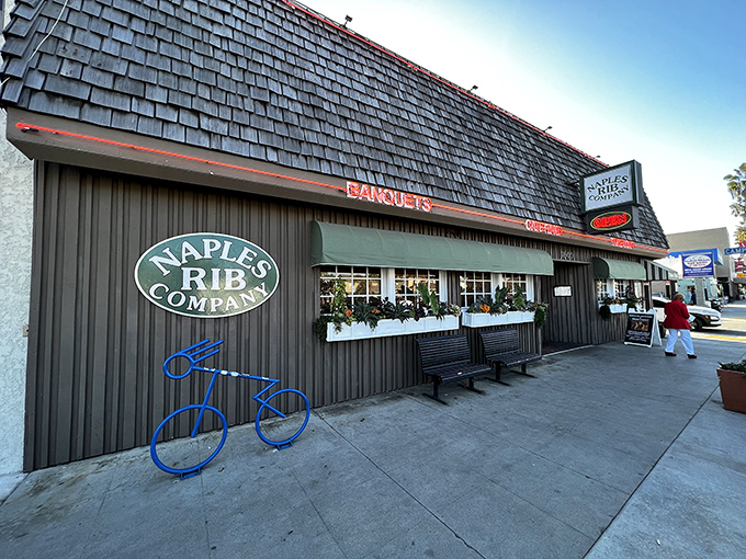 The exterior view showcases the restaurant's modest charm &ndash; complete with flower boxes and a blue bicycle that says "stay awhile."