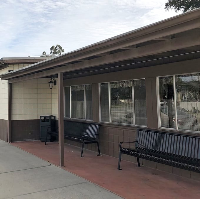 The waiting area where anticipation builds with every passing minute. Those benches have supported the weight of countless hungry expectations.