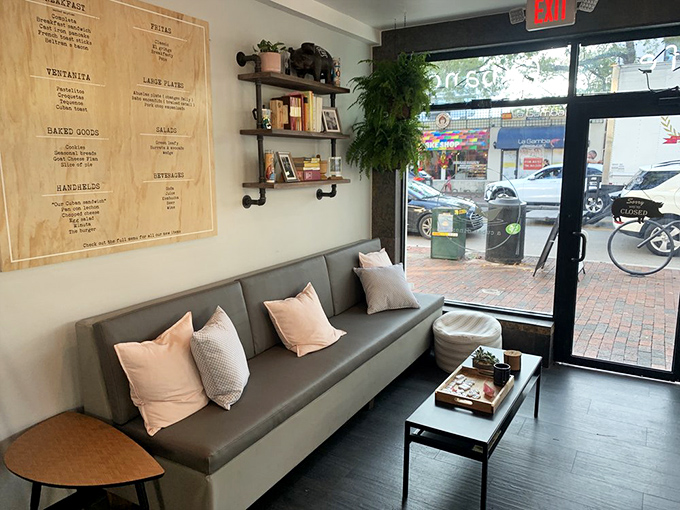 The waiting area that makes waiting a pleasure. Those pink pillows and wooden shelves create a living room vibe worth arriving early for.
