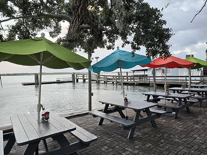 Waterfront dining with colorful umbrellas where the view competes with the food for your attention. Spoiler alert: it's a delicious tie.