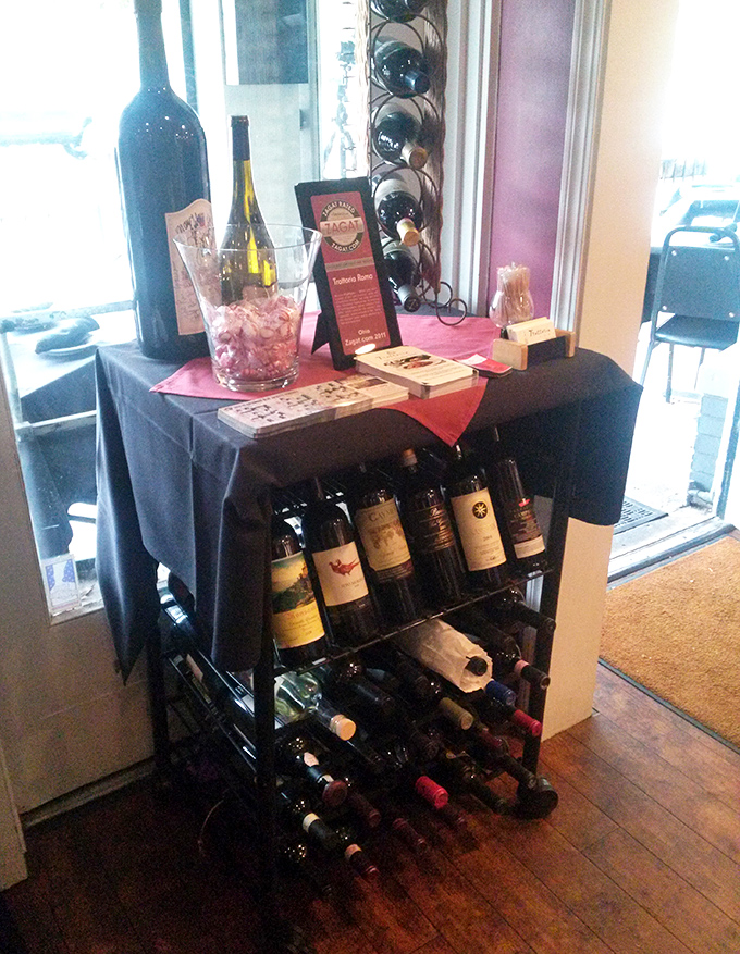 Wine bottles displayed like edible art, each one a different journey through Italy's diverse viticultural regions explored.