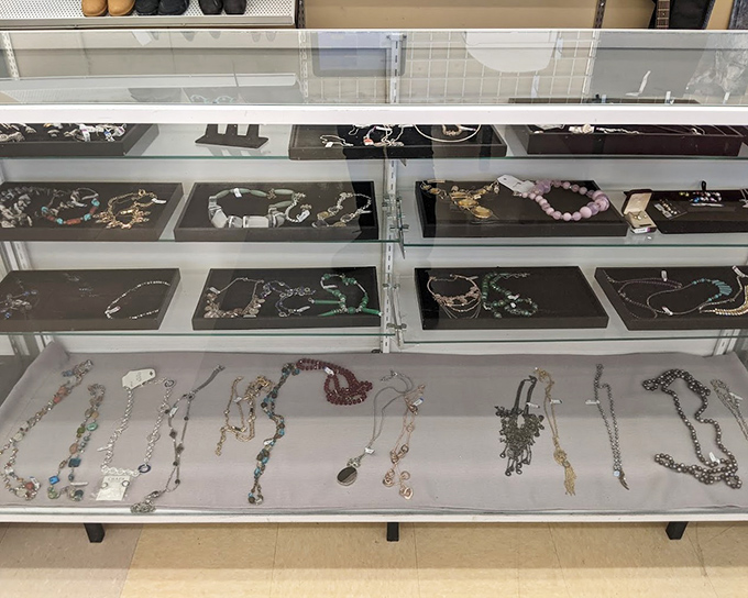 The accessories wall displays purses and bags that once accompanied someone to places now unknown but fascinating nonetheless.