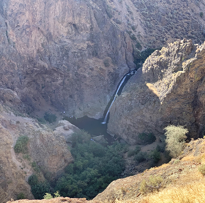 A bird's-eye perspective reveals the falls as a tiny thread of silver nestled in its dramatic canyon setting.