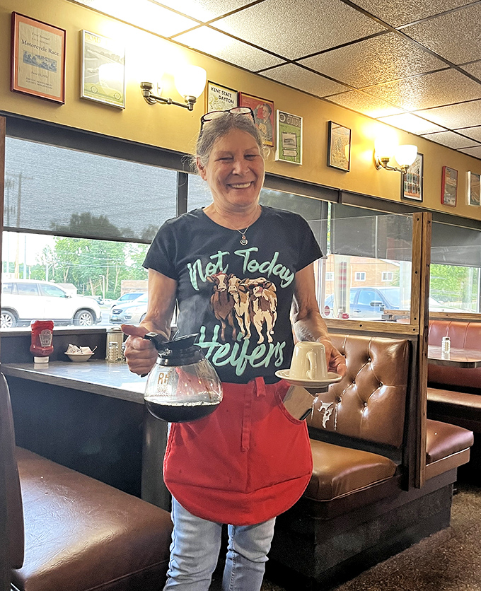 A friendly server with coffee pot in hand &ndash; the unsung hero of every great breakfast experience, keeping cups full and spirits high.
