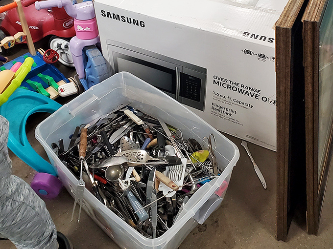 Kitchen utensil chaos! This container holds enough gadgets to outfit three restaurants. That ice cream scoop has seen things you wouldn't believe.