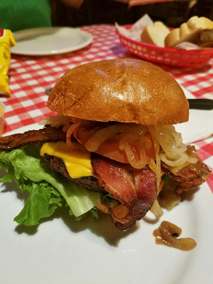 This isn't just a burger – it's a towering achievement of beef, bacon, cheese, and onions that requires jaw exercises before attempting.