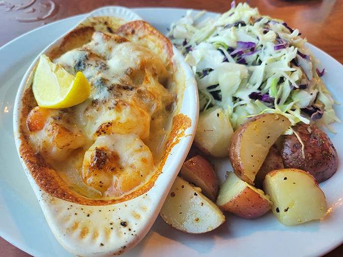 Baked scallops bubbling with cheese alongside potatoes and slaw&mdash;the holy trinity of comfort that makes you want to hug the chef.