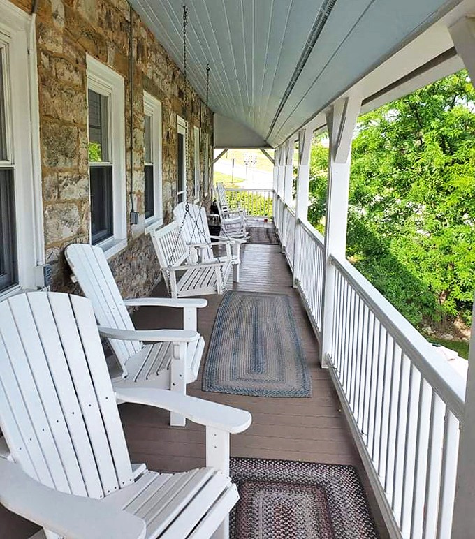 A front porch that invites you to rock away your worries. White Adirondack chairs offer the perfect perch for contemplating simpler times.