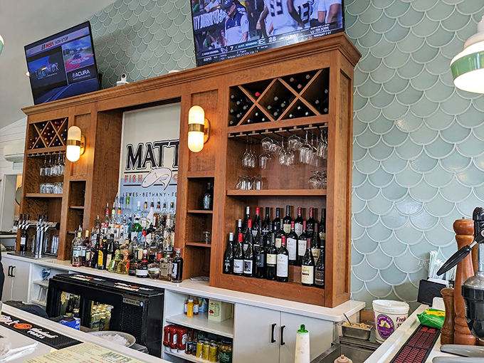 The bar area combines coastal charm with serious libation credentials. Those scalloped tiles whisper "you're at the beach" with every sip.