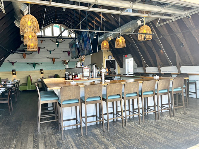 The bar area feels like the hull of a stylish ship. Those basket pendant lights cast the kind of glow that makes everyone look like they're on vacation.