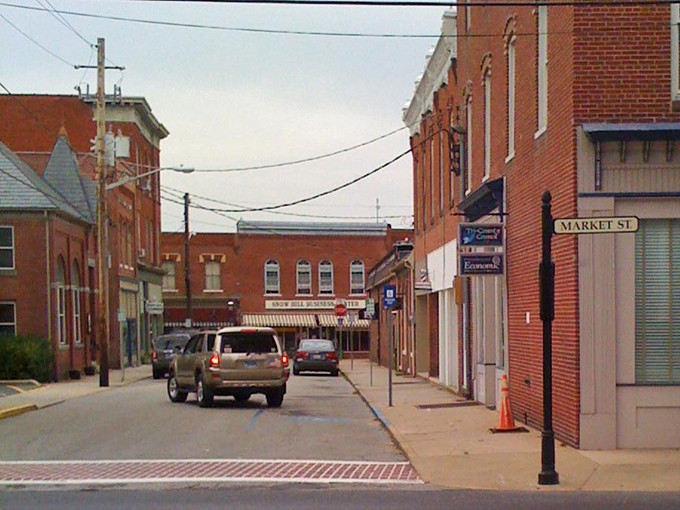Market Street's brick buildings create a corridor of commerce that hasn't changed much in a century. Time moves differently on these sidewalks.