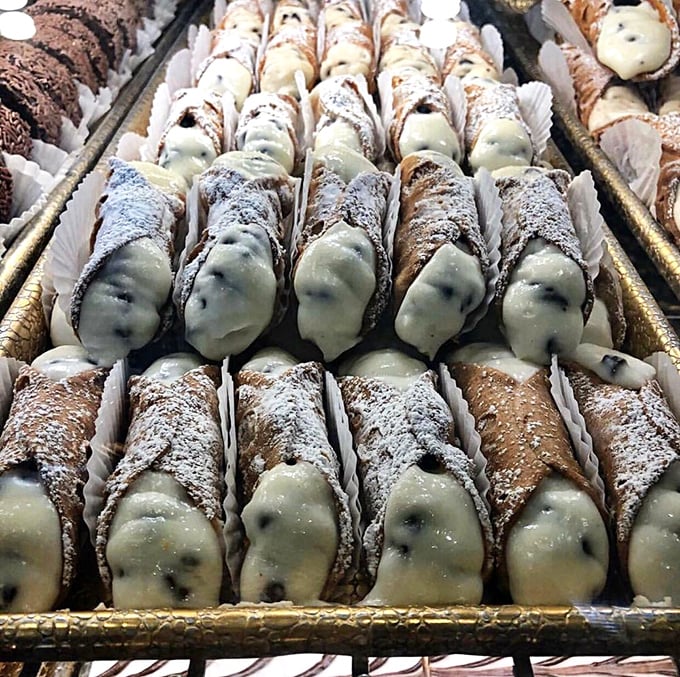 Cannoli lined up with military precision, cream-filled soldiers in the army of indulgence. Each one a perfect cylinder of ricotta-filled bliss.