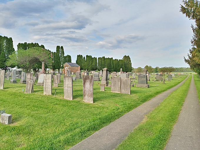 Cemetery paths wind through weathered headstones under open skies, offering peaceful reflection in a setting that honors the past without feeling heavy or depressing about mortality's inevitability.