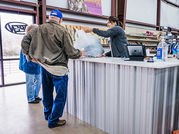 The checkout – where thrifting victories become official. That smile says "I just got three bags of treasure for under $25."