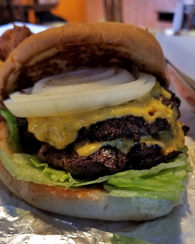 This isn't just a burger &ndash; it's a masterclass in beef architecture with perfectly melted cheese cascading down like a yellow waterfall.