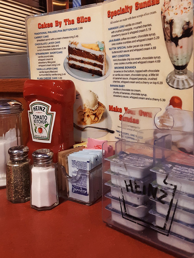 The holy trinity of diner dining—Heinz ketchup, salt and pepper shakers, and a dessert menu that makes saying "I'll just have coffee" nearly impossible.